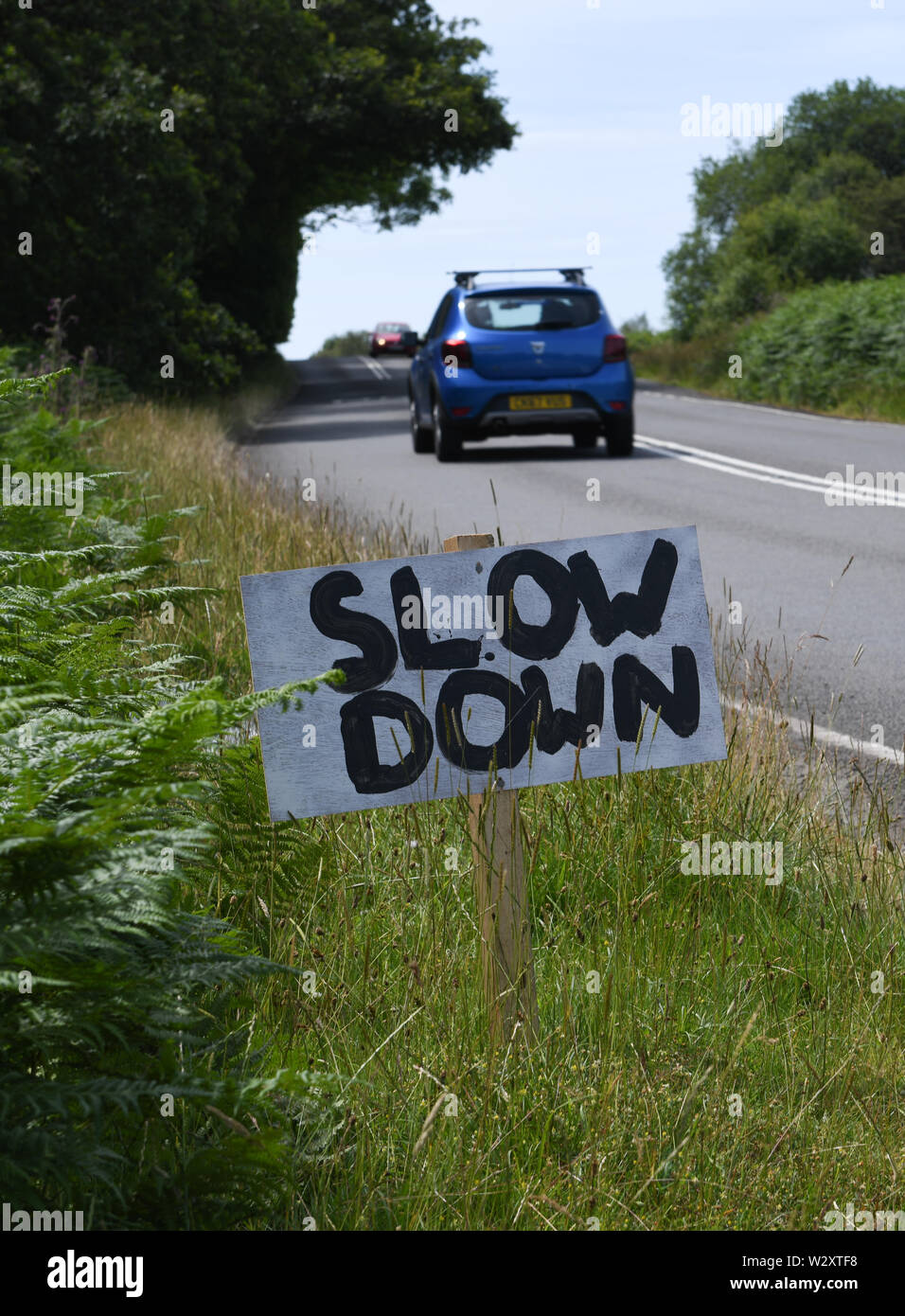 Slow down road sign hi-res stock photography and images - Alamy