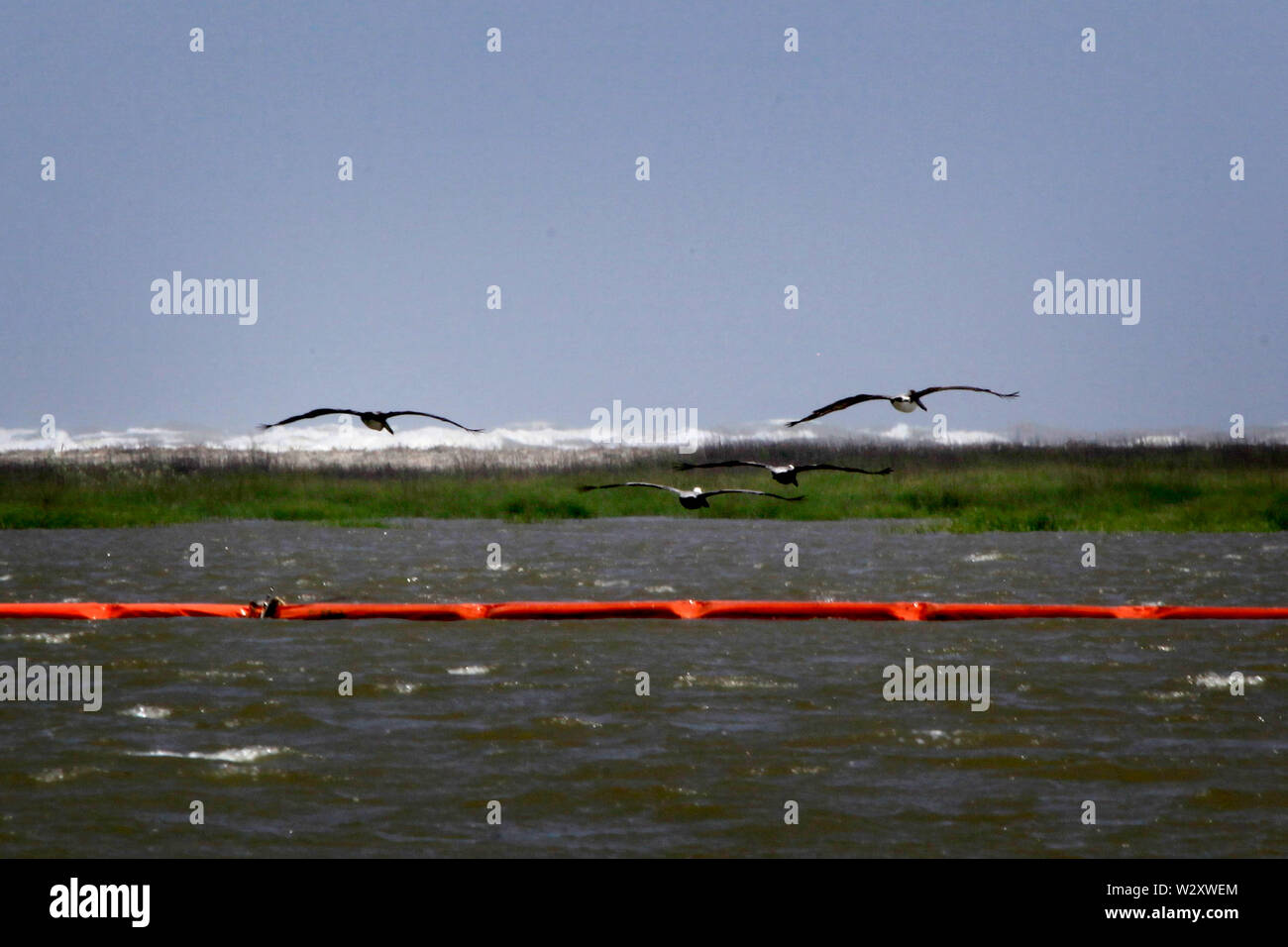Oil booms tossed around in the ocean outside Port Eads at the mouth of ...