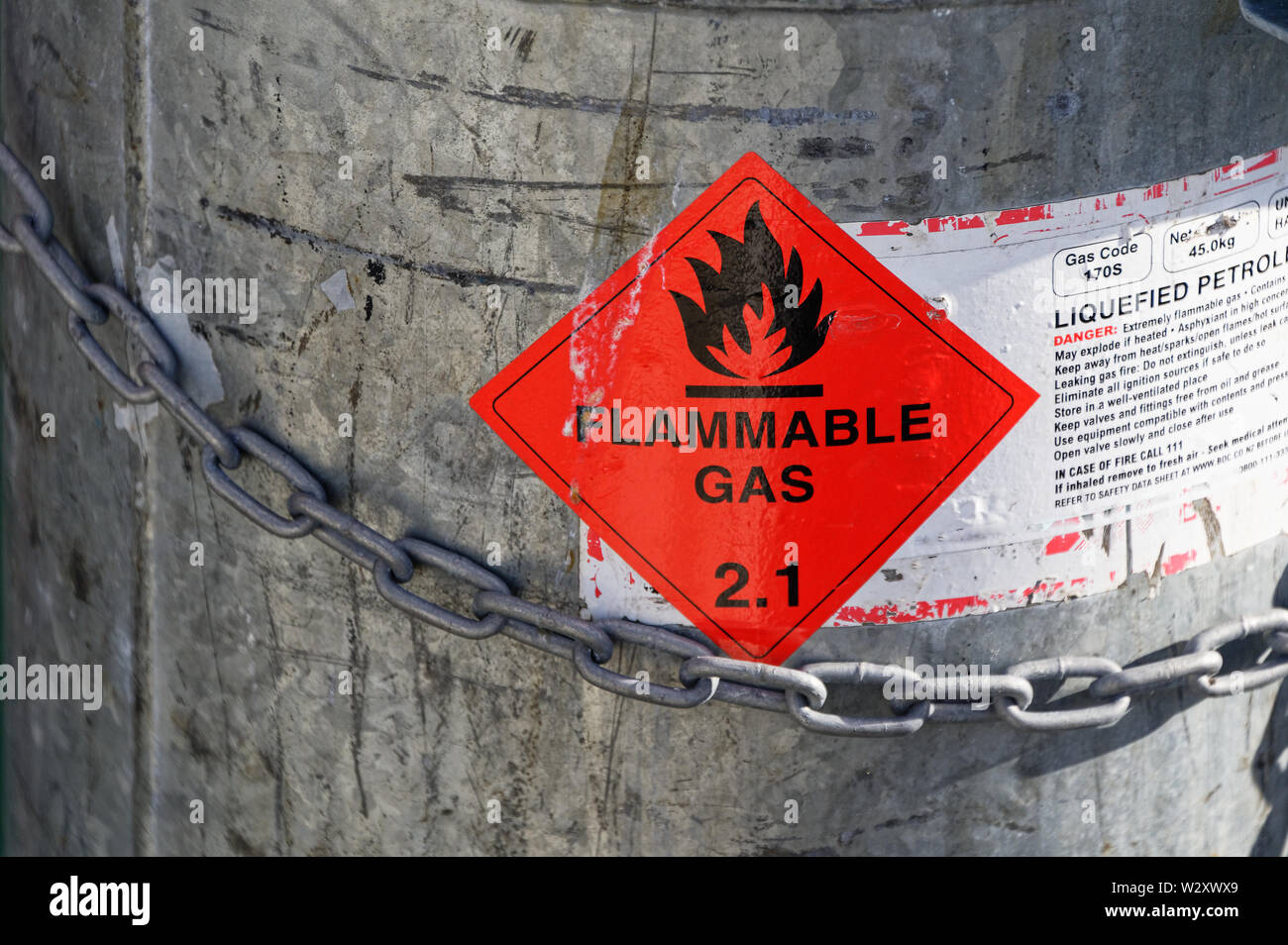 An LPG tank secured with a strong chain and showing a Flammable Gas 2.1 ...