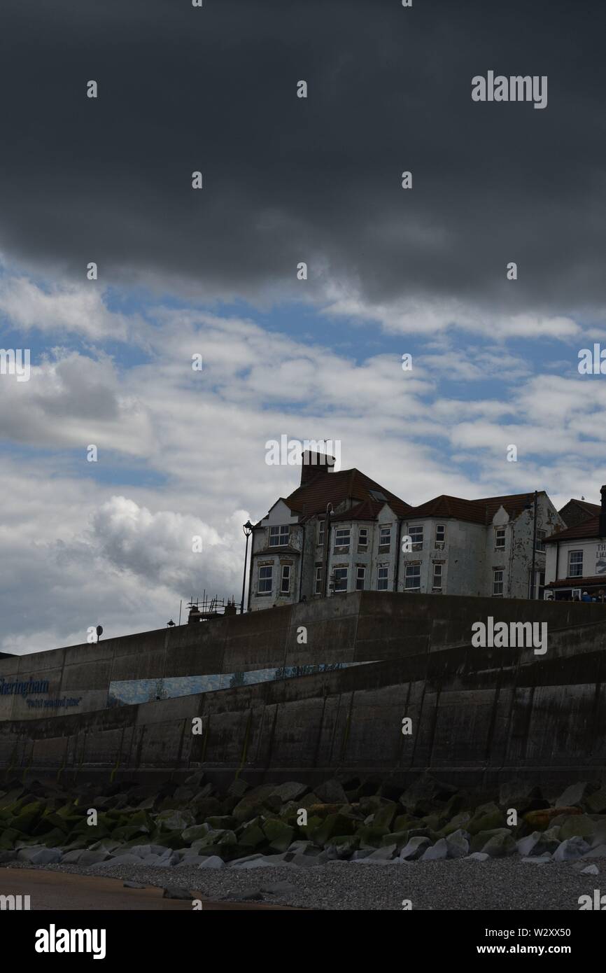 half sun setting over trees in pastel pale sky Stock Photo - Alamy
