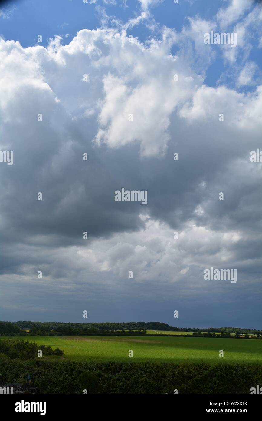 skyscape of large cloud over fields on the coast of England Stock Photo ...