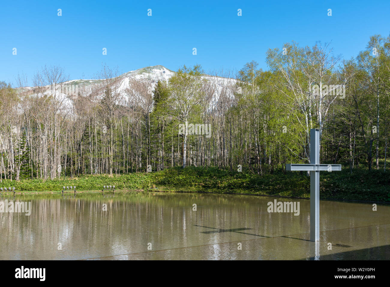 Cross on the water with an inverted reflection in a beautiful nature ...