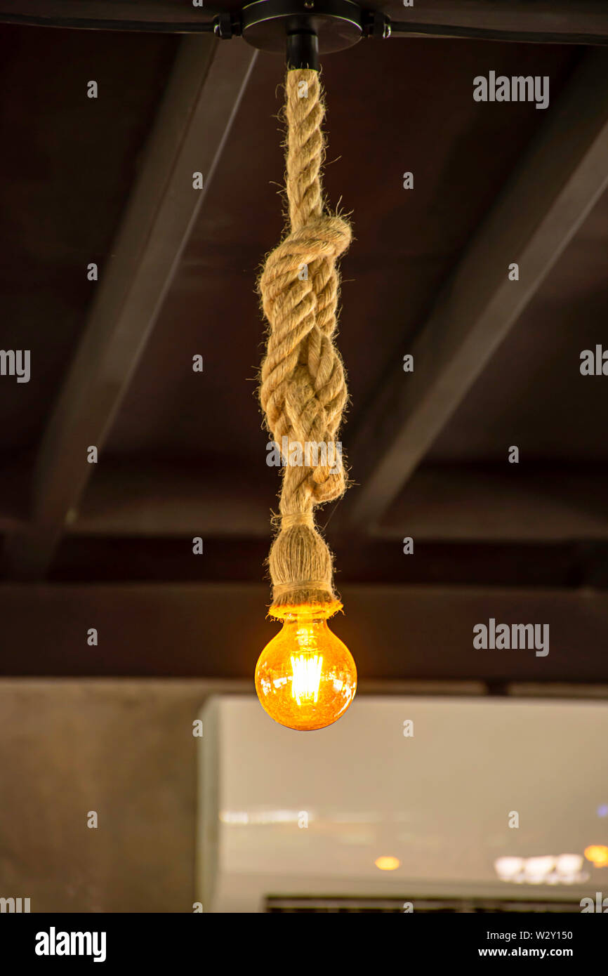 Yellow light bulb The sphere hanging with a rope Stock Photo - Alamy