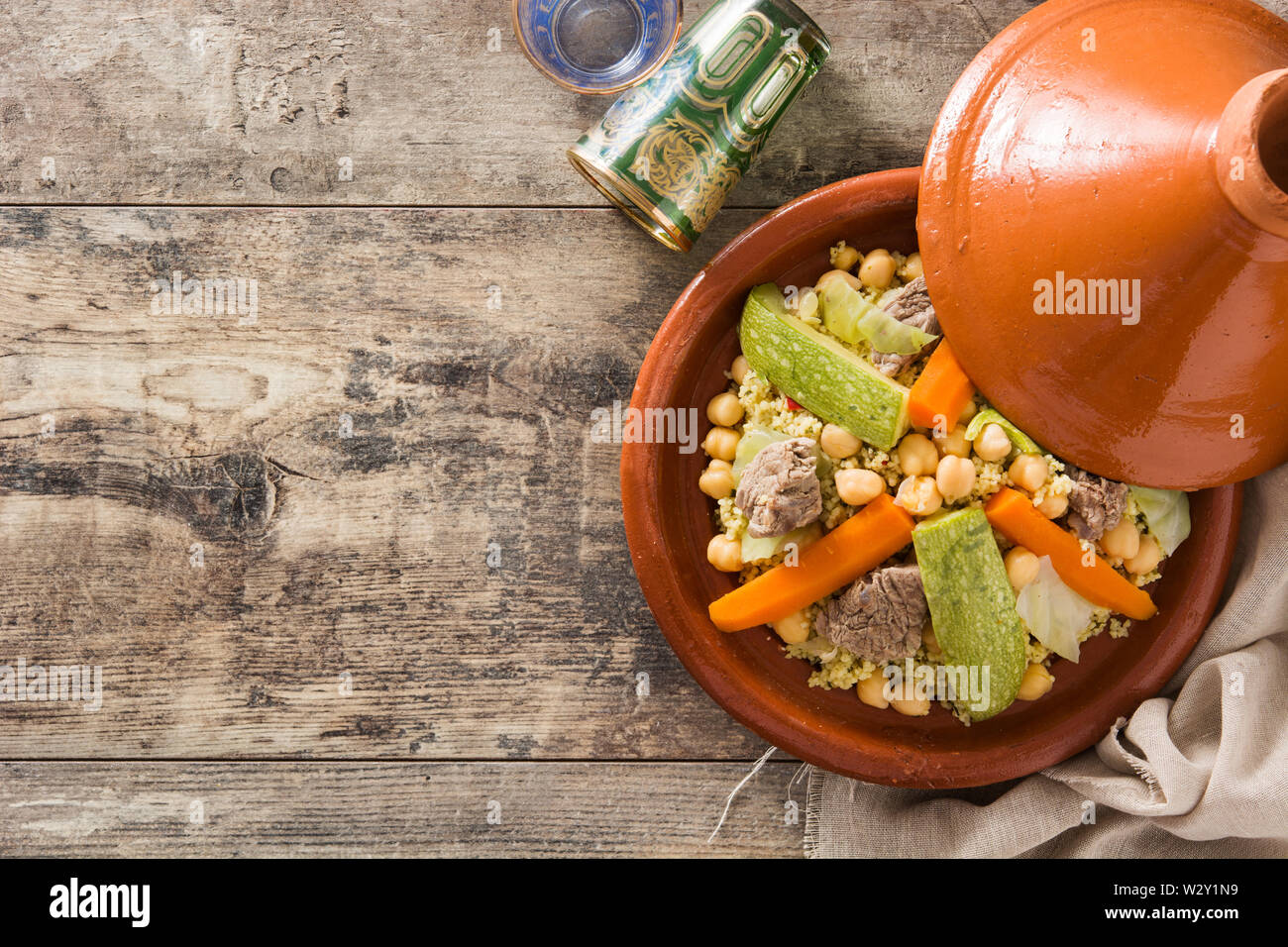 Traditional tajine with vegetables, chickpeas, meat and couscous on ...
