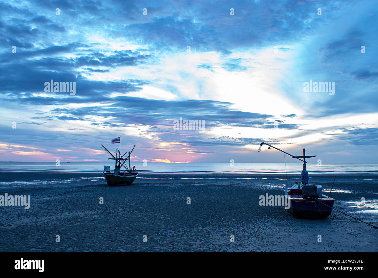 The morning sun light in the sea, and the boat on the beach Stock Photo ...