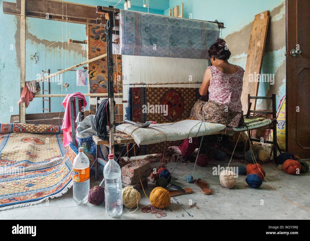 Women weaving rugs on a loom in her studio Stock Photo - Alamy