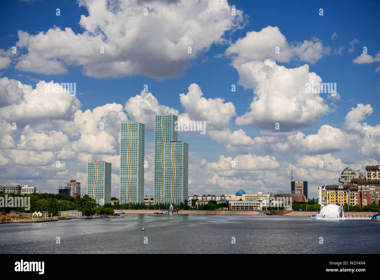 Quay of the river Ishim in Astana. Residential district Grand Alatau in ...