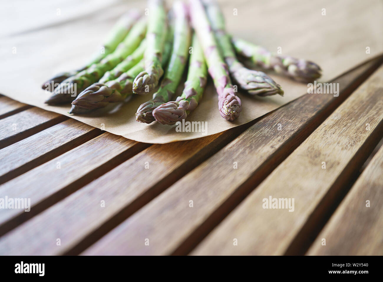 Fresh green asparagus on wooden table background Stock Photo - Alamy