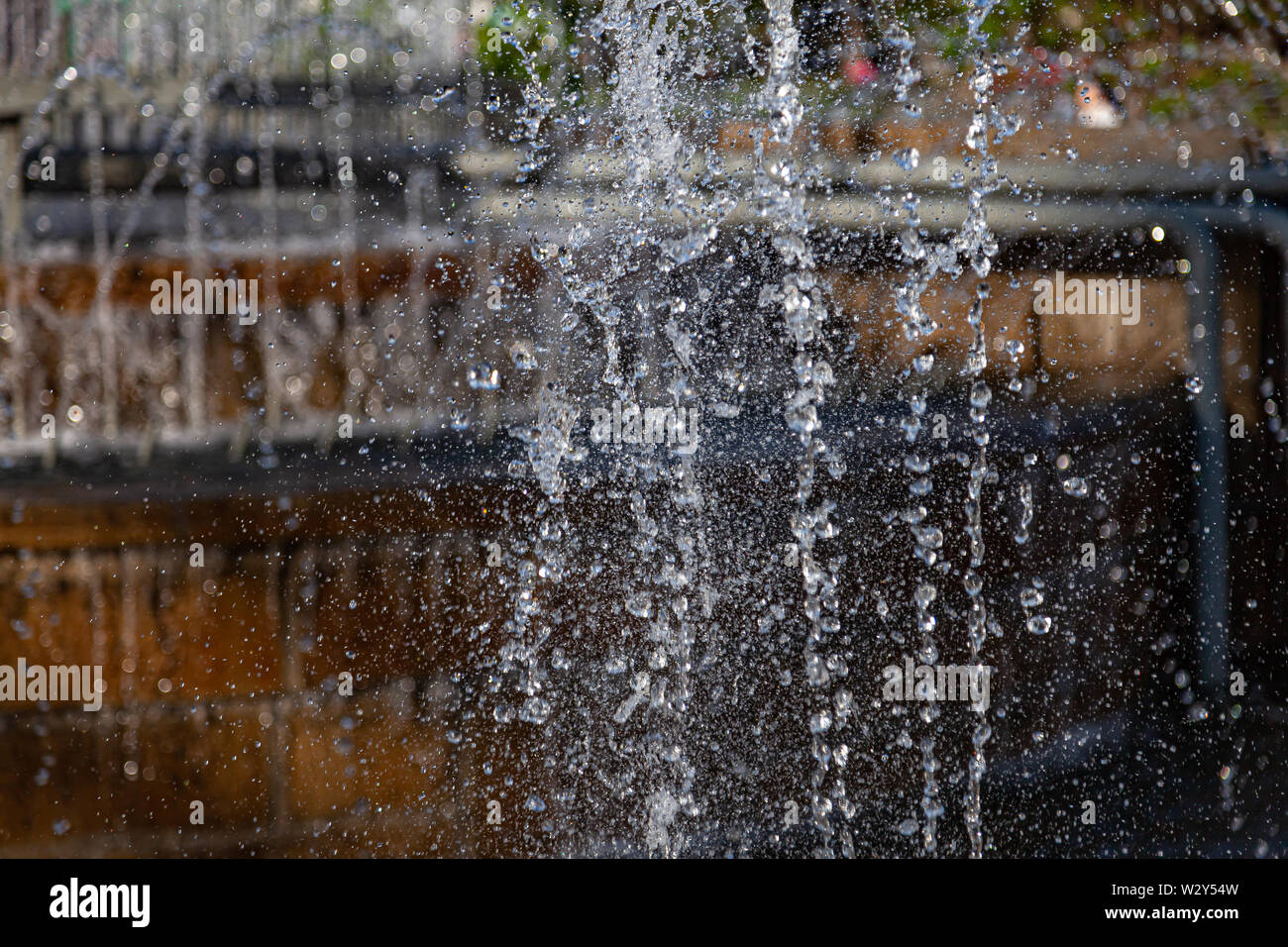 City fountain with splashes and jets of water hardened on a clear ...