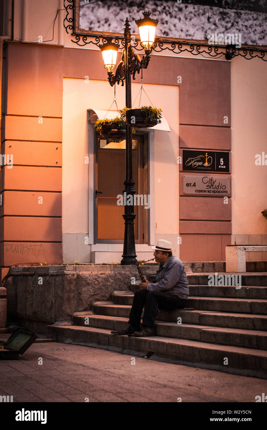 Man sat on street hi-res stock photography and images - Alamy