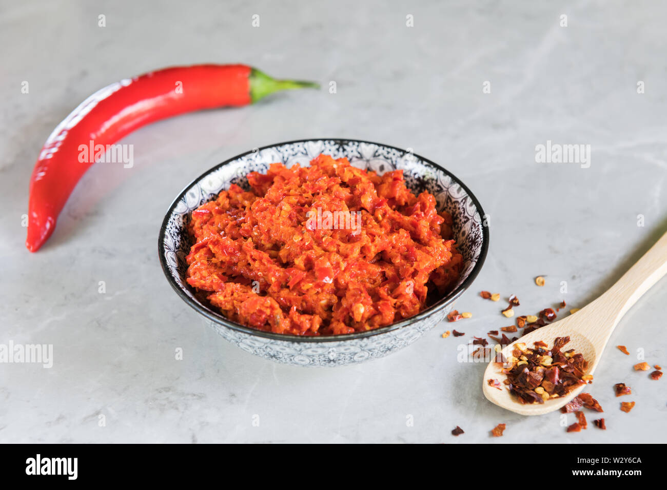Traditional Maghrebi hot chili pepper sauce harissa on a grey marble ...