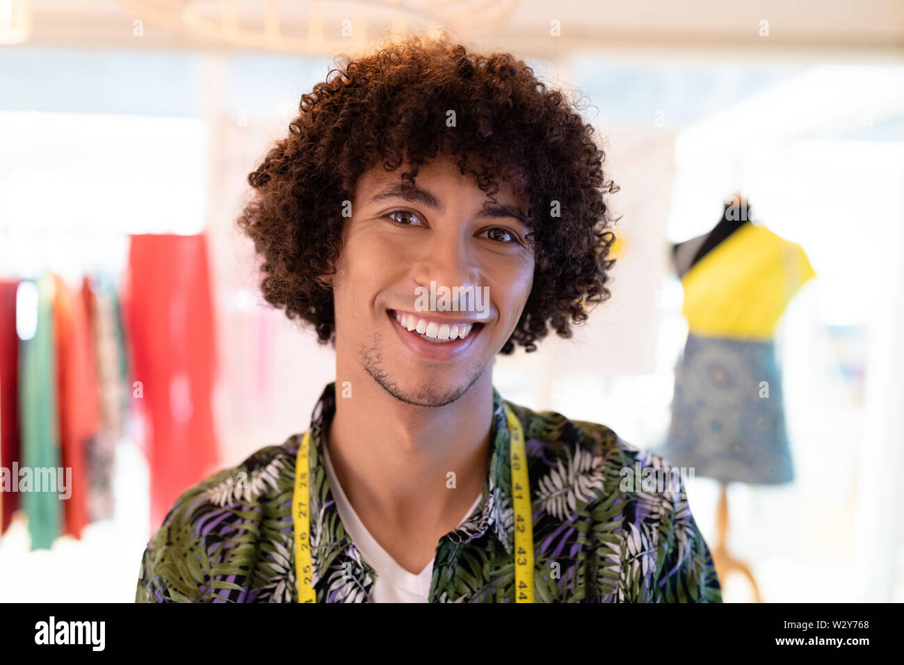 Male fashion designer smiling in design studio Stock Photo - Alamy
