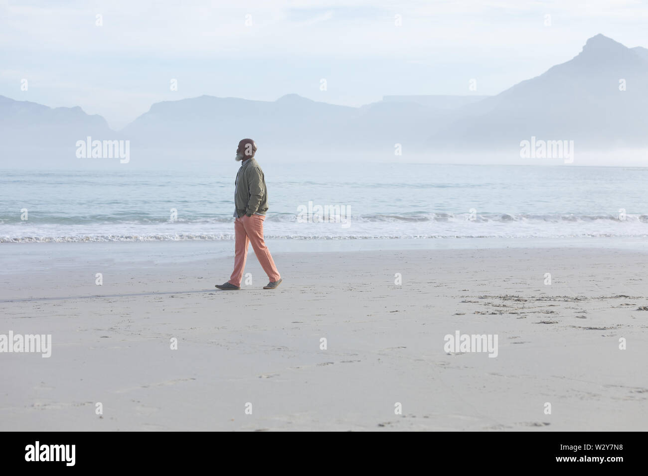 Man walking by the beach Stock Photo - Alamy