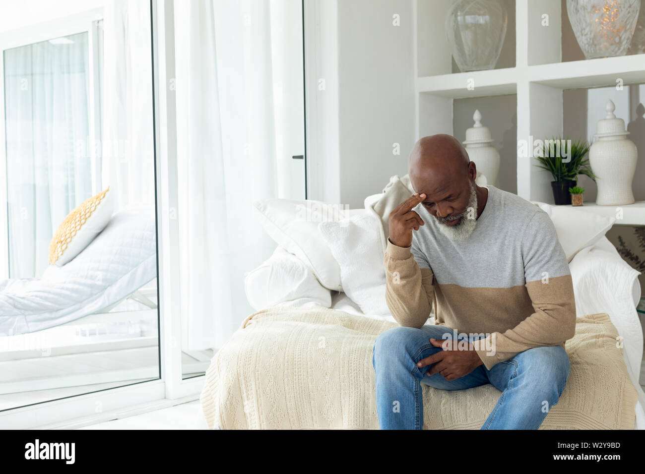 Man thinking while sitting inside a room Stock Photo - Alamy
