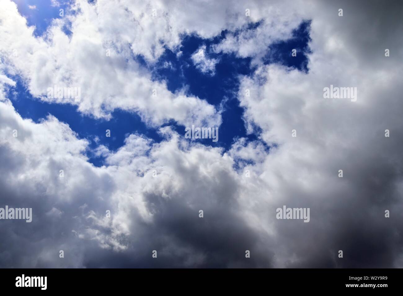 Relaxing view on fluffy white clouds on a deep blue sky Stock Photo - Alamy