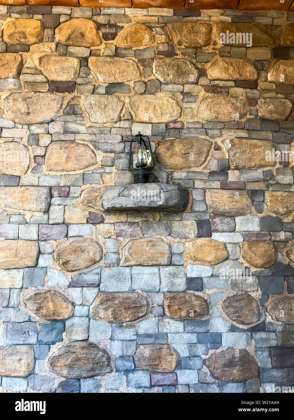 Decorative wall of colored stone bricks Stock Photo - Alamy