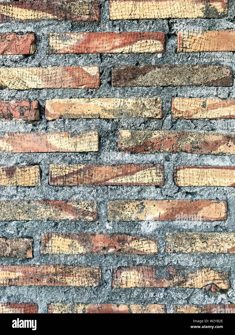 Decorative wall of colored stone bricks Stock Photo - Alamy