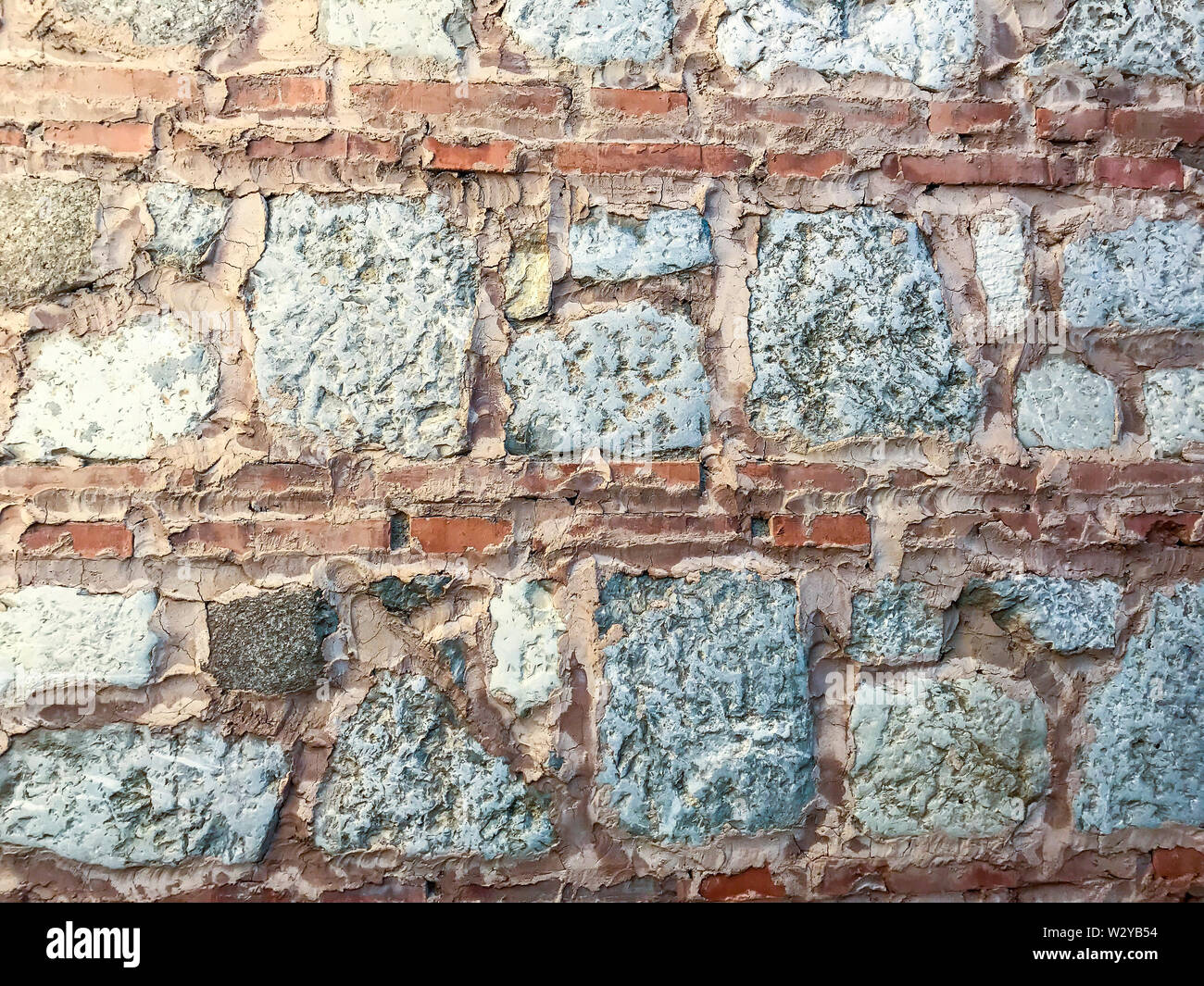 Decorative wall of colored stone bricks Stock Photo - Alamy