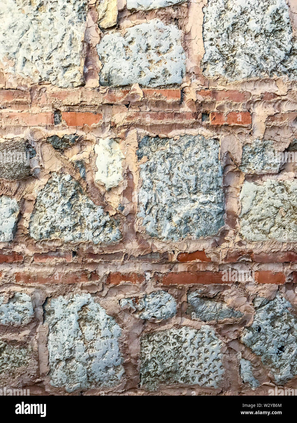 Decorative wall of colored stone bricks Stock Photo - Alamy