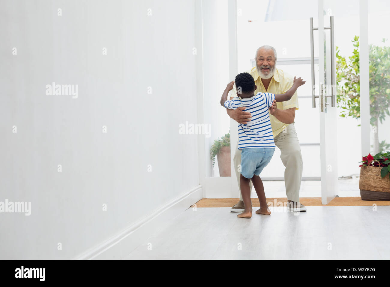 Boy reaching out to hug grandmother Stock Photo - Alamy