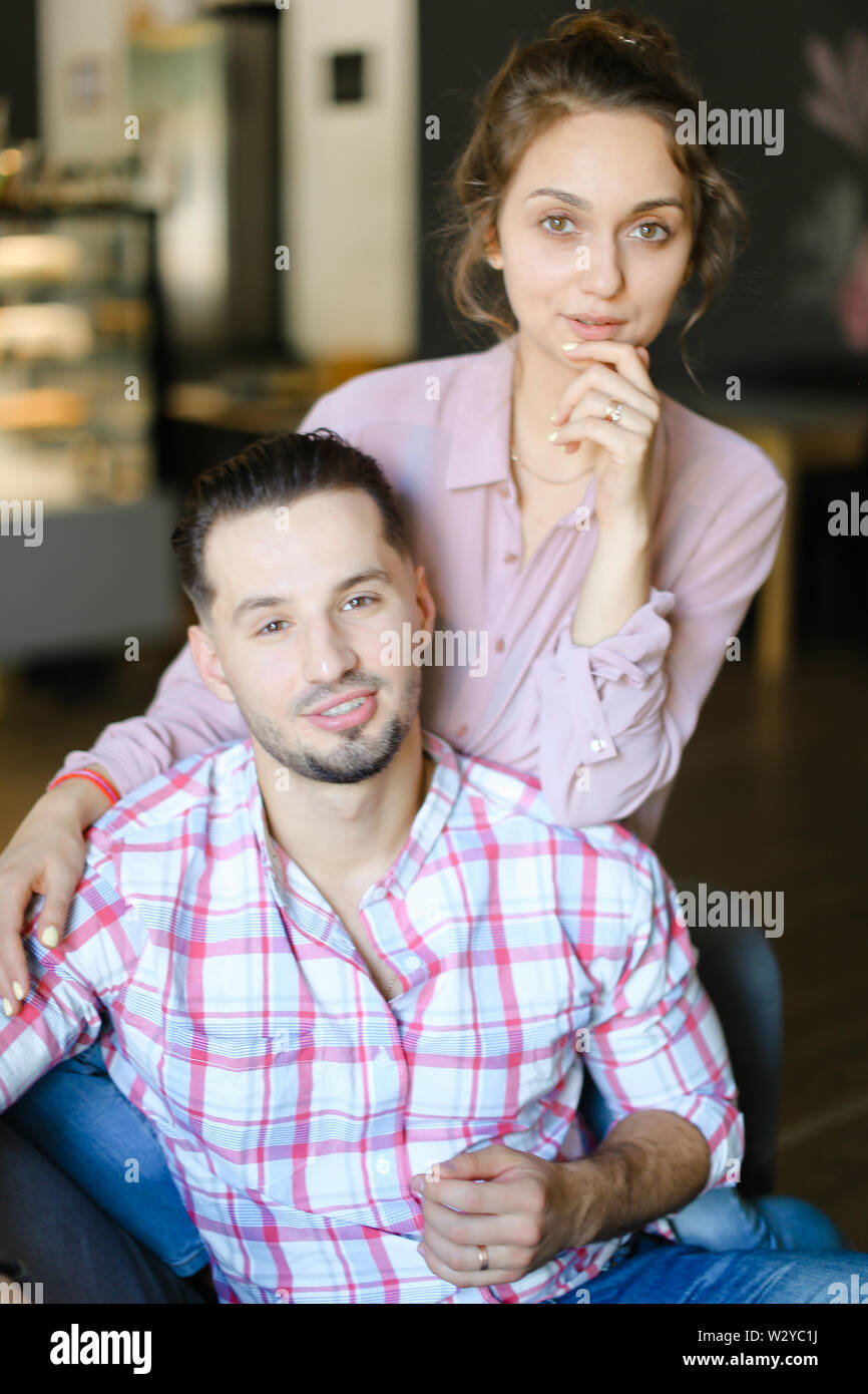 Happy handsome husband sitting with nice wife at home. Concept of ...