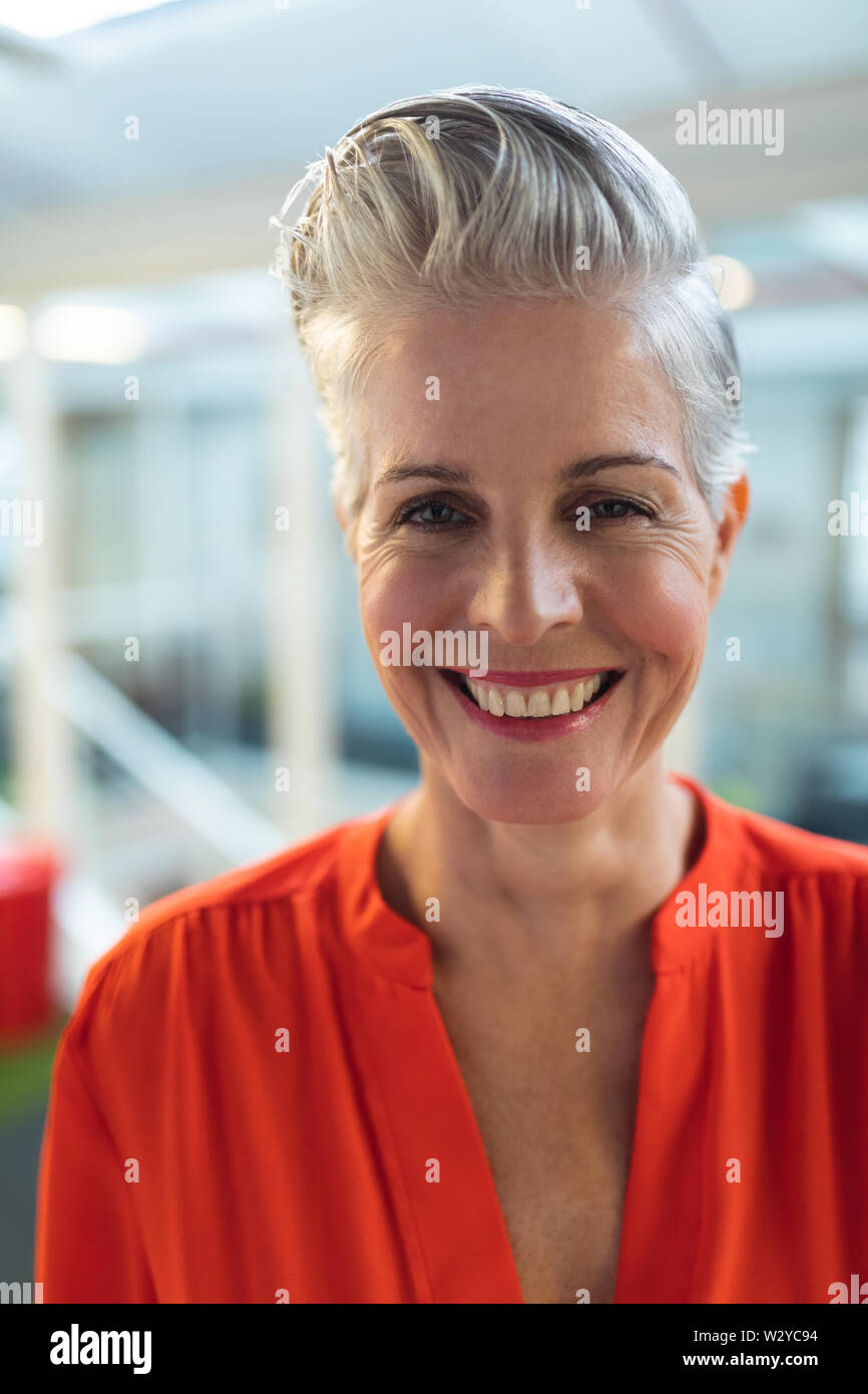 Female graphic designers smiling in office Stock Photo - Alamy
