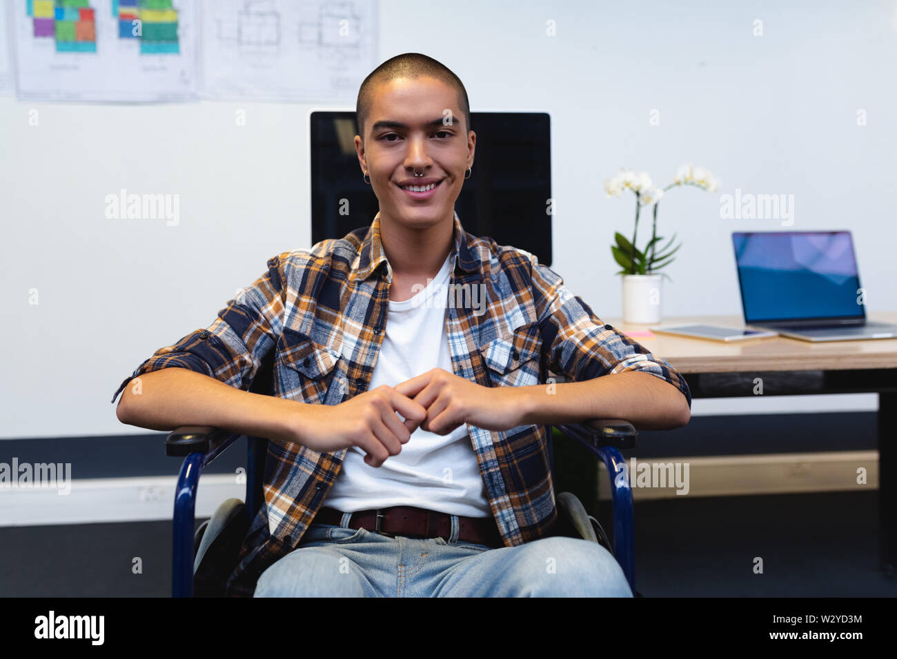 Disabled male executive smiling at desk in office Stock Photo - Alamy