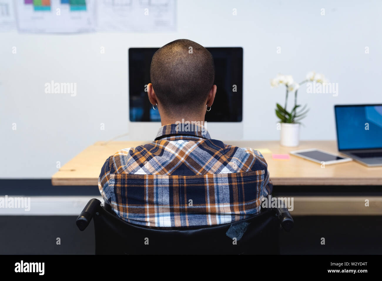 Disabled male executive working on computer at desk in office Stock ...