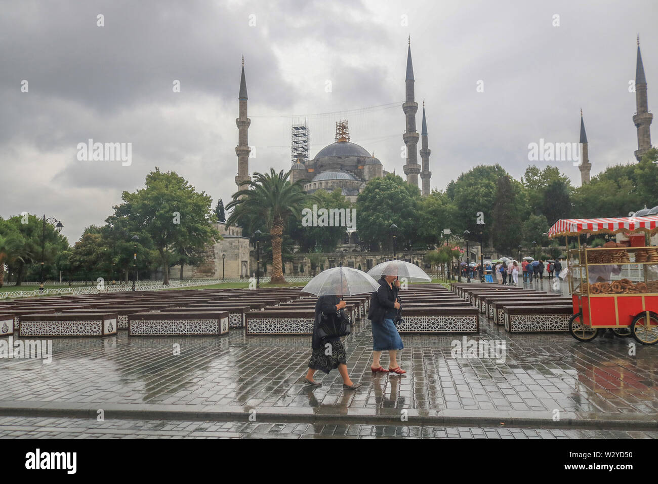 Istanbul Turkey. 11th July 2019. Tourists shelter with umbrellas form ...