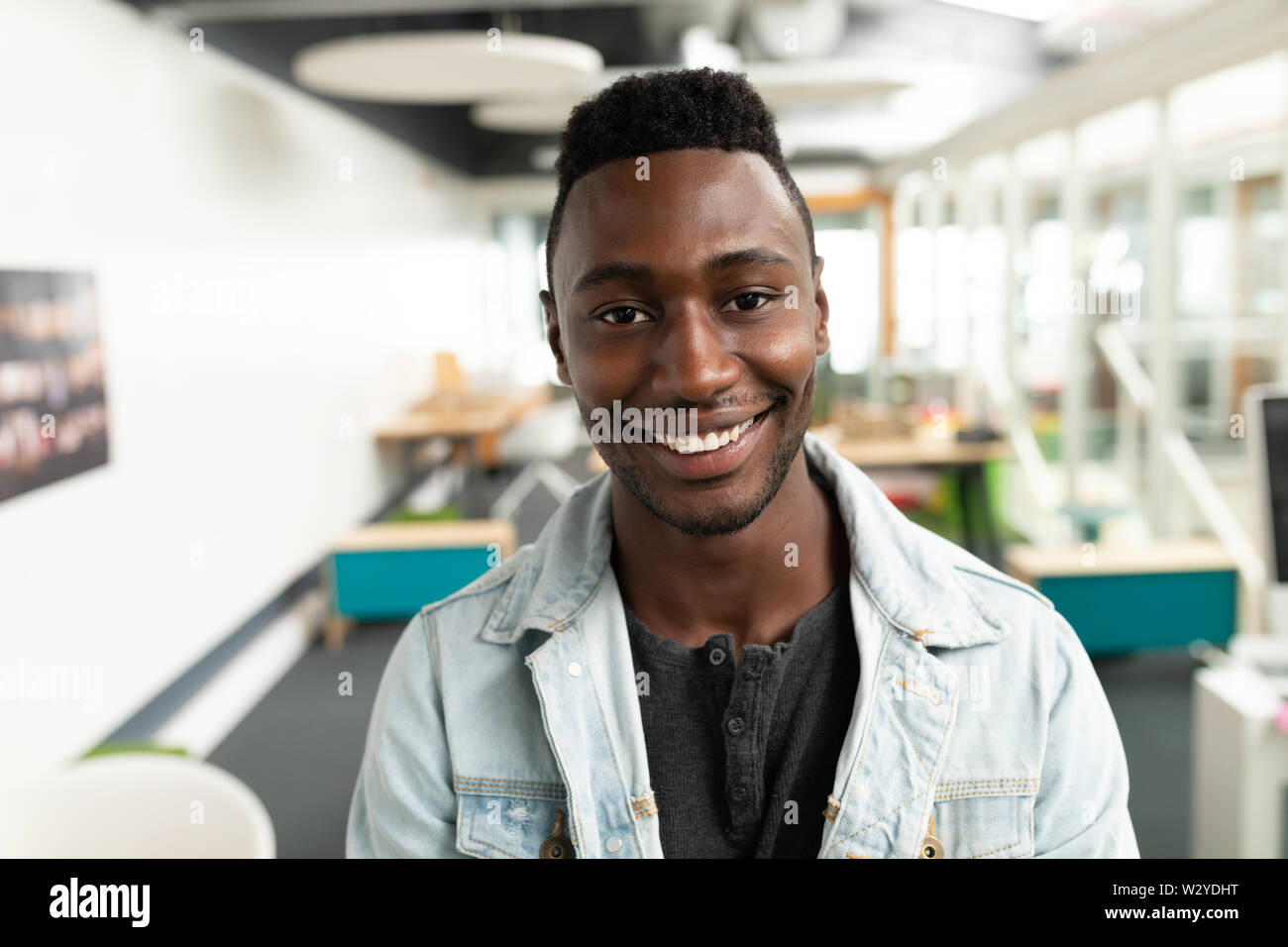 Male graphic designer smiling in office Stock Photo - Alamy