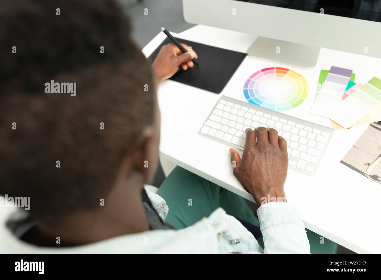 Male graphic designer using graphic tablet at desk in office Stock ...
