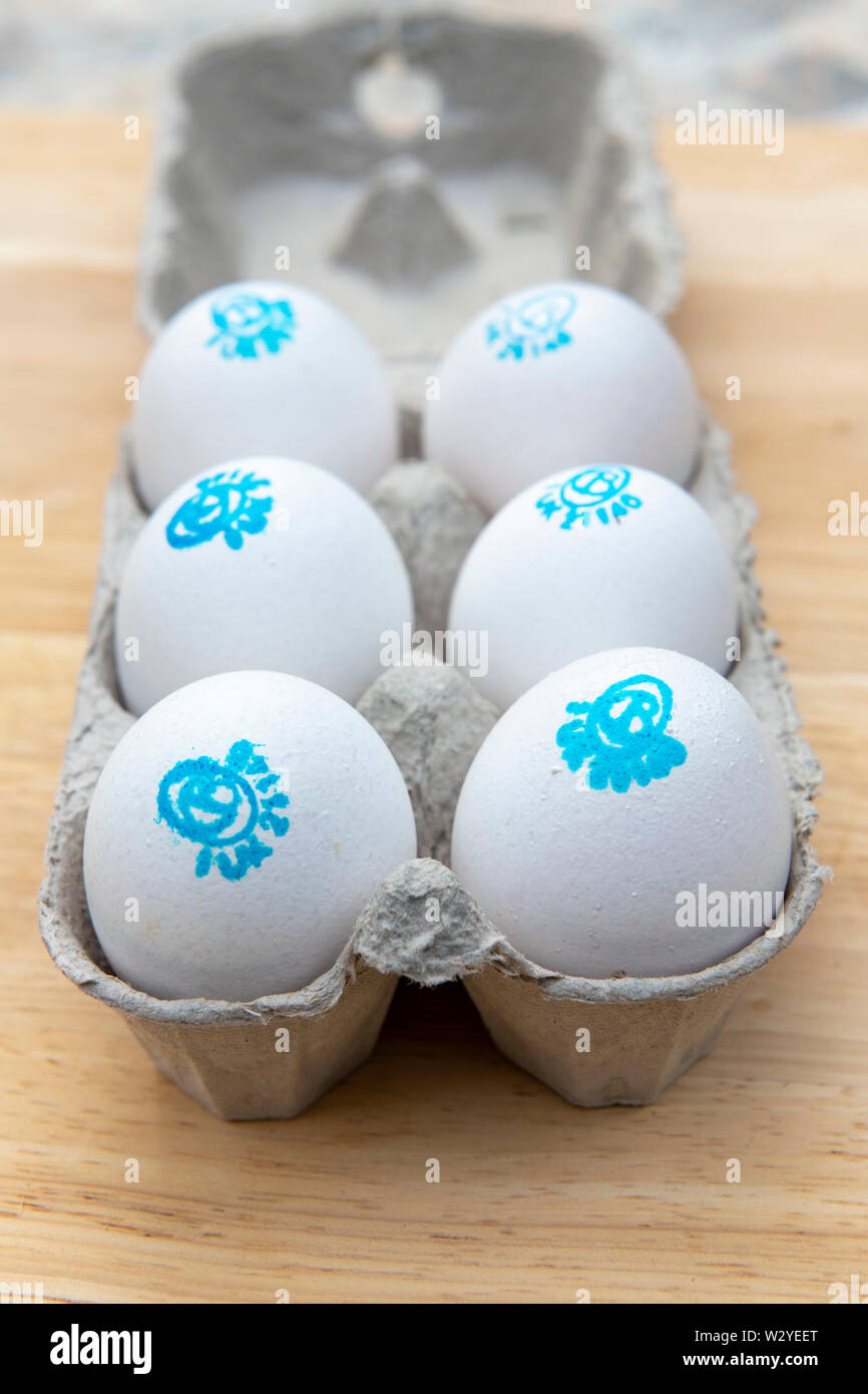 Cacklebean White free range hens eggs with a blue stamp in an eggbox ...