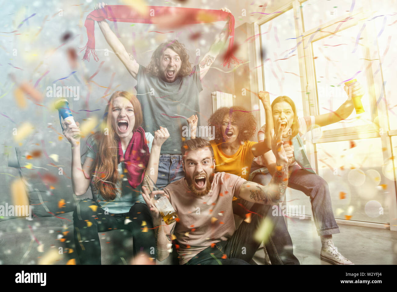Football fans celebrating on sofa hi-res stock photography and images ...