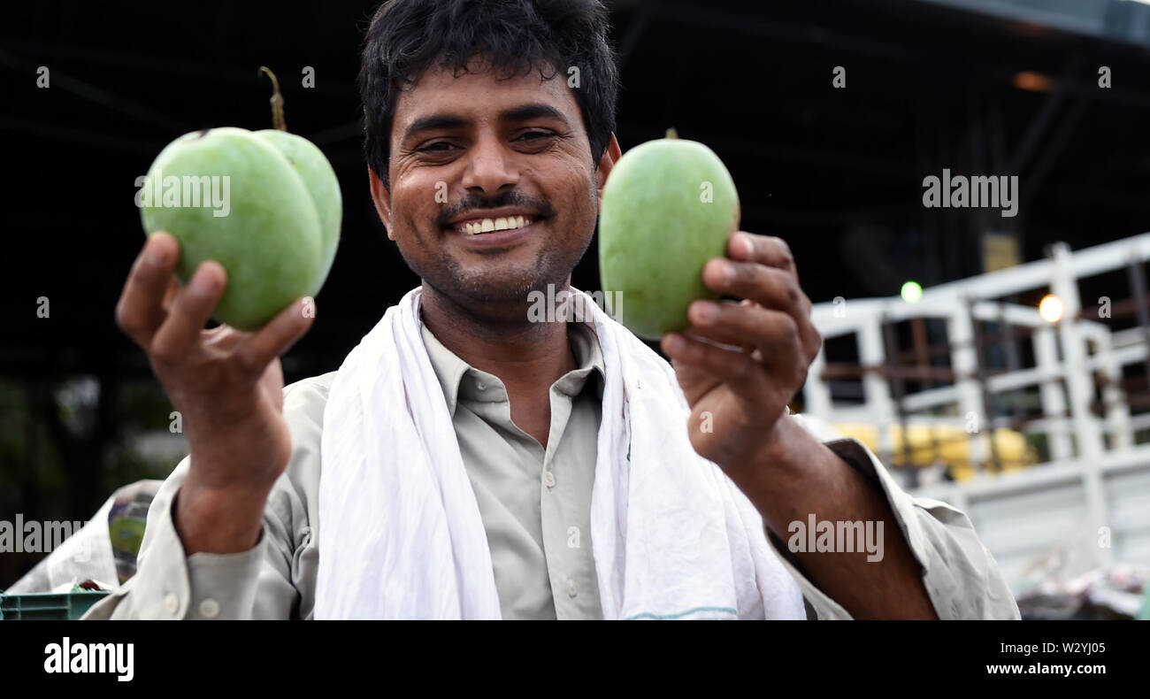 New Delhi, India. 11th July, 2019. A peddler sells mangoes in a fruit ...
