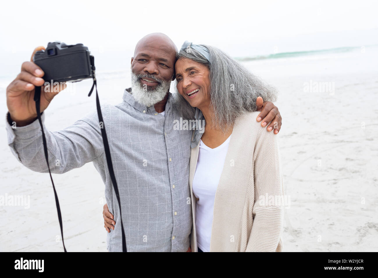 Couple taking a picture with digital camera on the beach Stock Photo ...