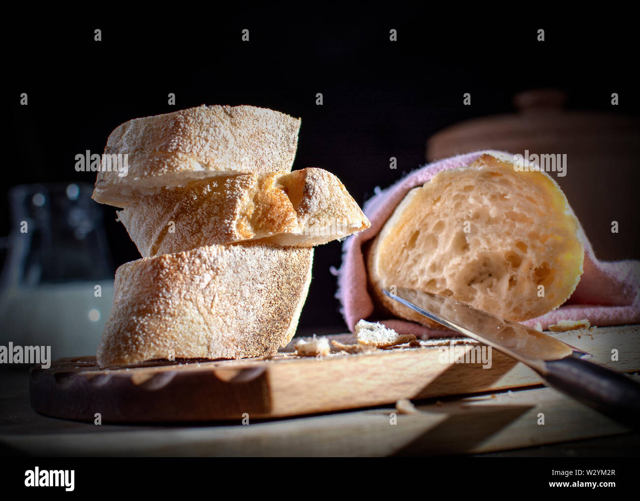 breadtime with al loaf of bread, sausage, cold cuts, pickles tomatoes ...