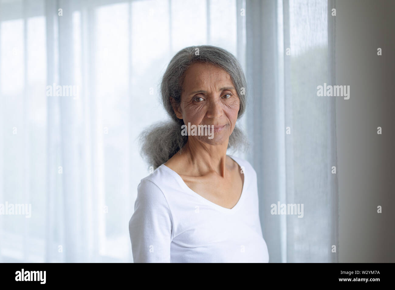 Woman standing inside hi-res stock photography and images - Alamy