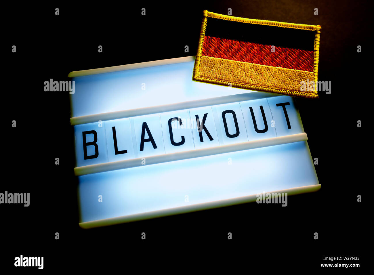 The word blackout on an illuminated panel and flag of Germany, power ...