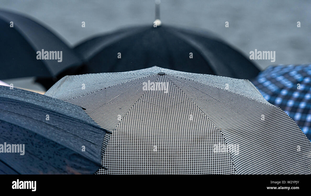 Busy street with crowd of people with umbrellas Stock Photo - Alamy