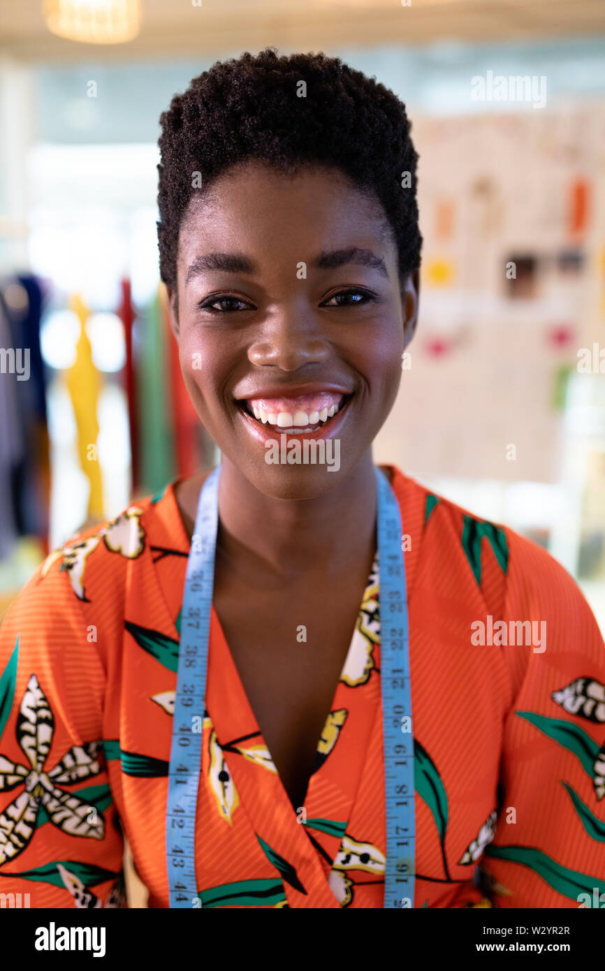 Female fashion designer smiling in design studio Stock Photo - Alamy