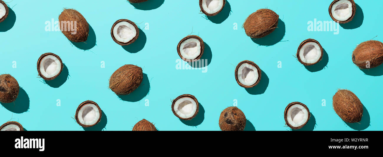 Creative layout of coconuts half on blue background. Tropical pattern ...