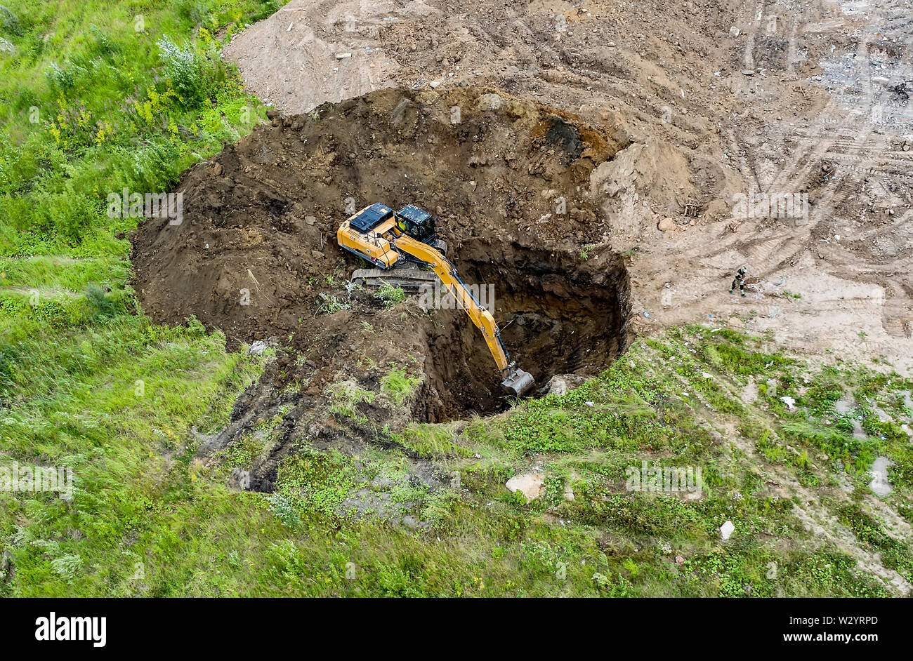 Aerial view of the excavator digging a large pit Stock Photo - Alamy