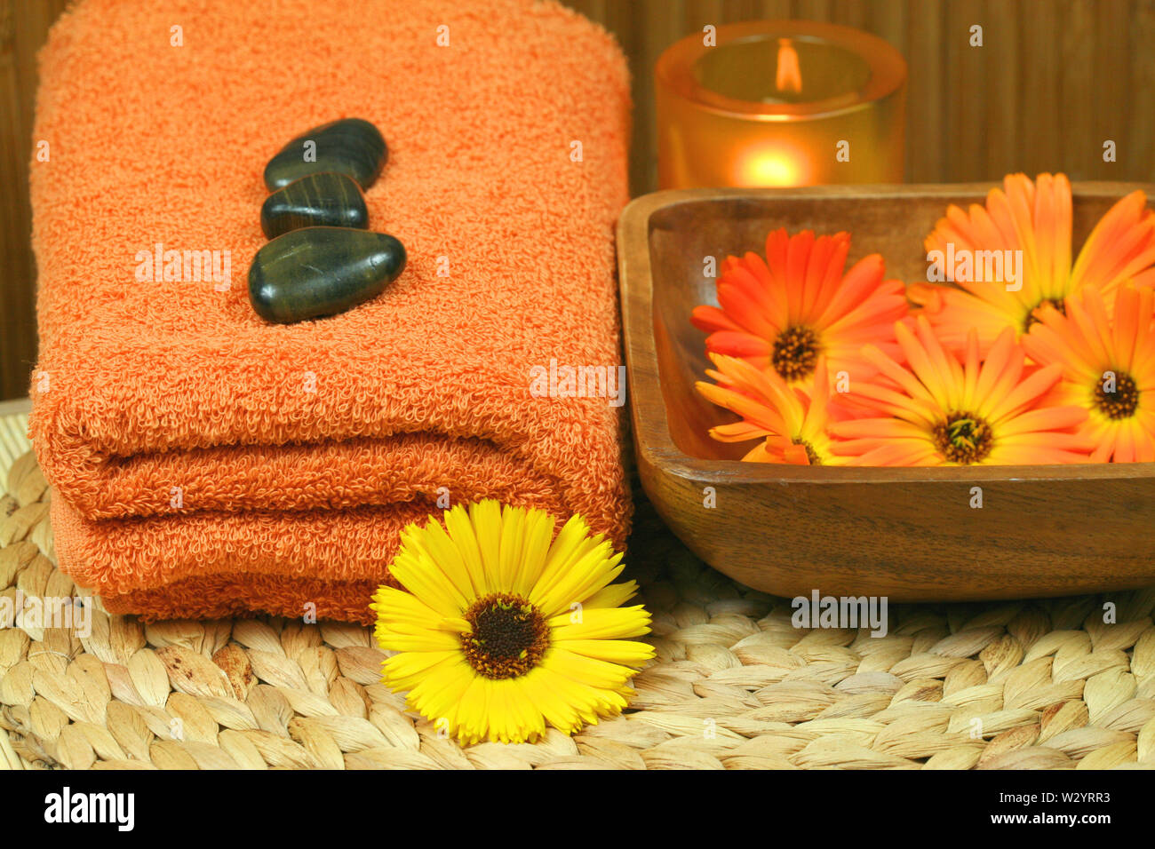 Spa therapy with orange marigold flowers. Massage tools Stock Photo - Alamy
