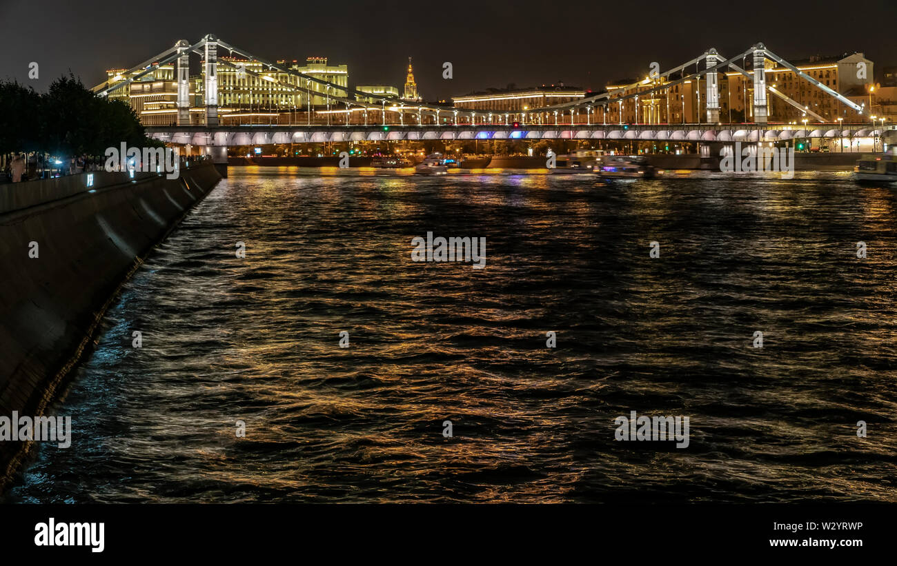 view of illuminated night river , embankment and the movement of river ...