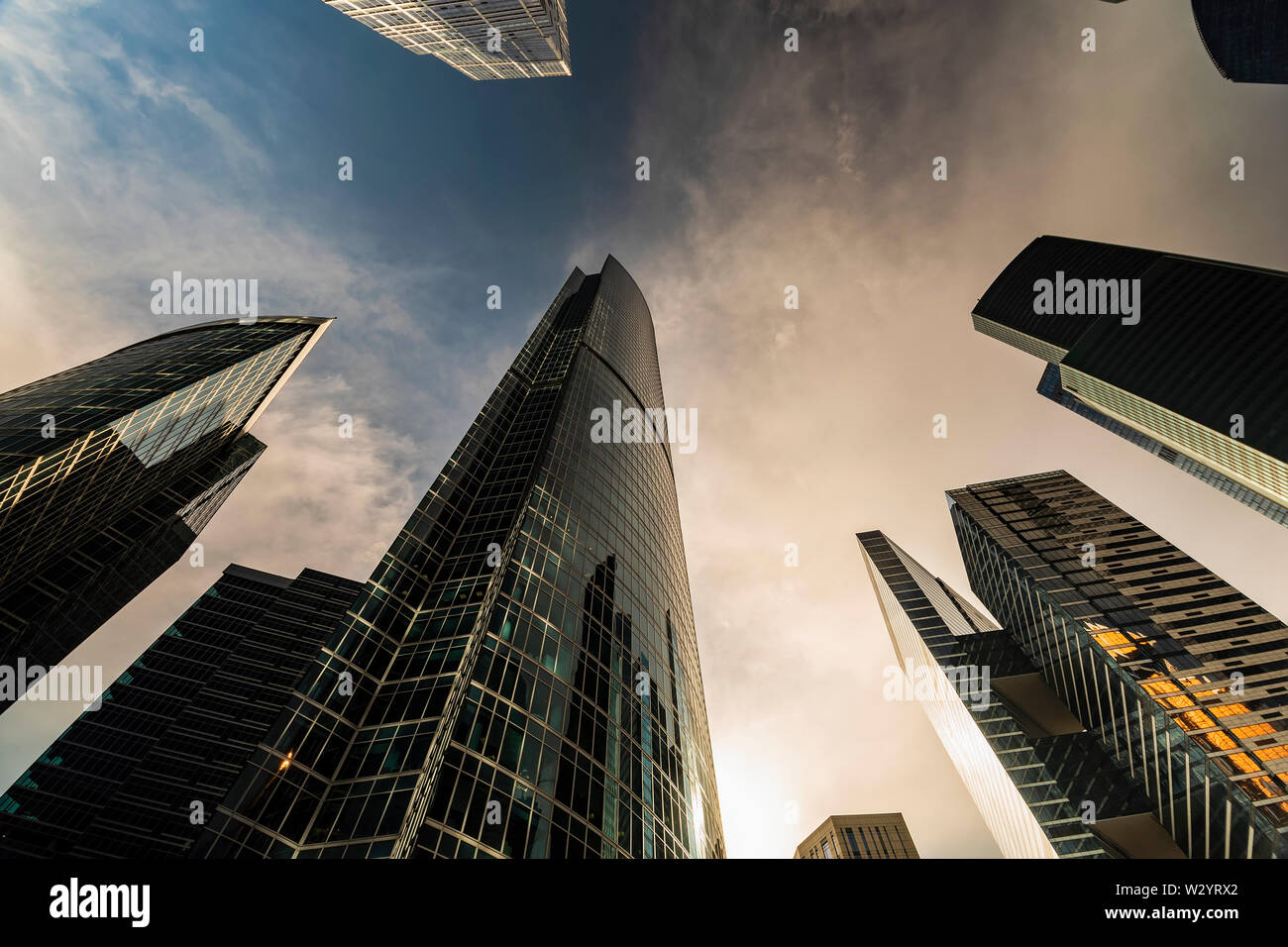 bottom-up view of rotating skyscrapers and flying clouds Stock Photo ...