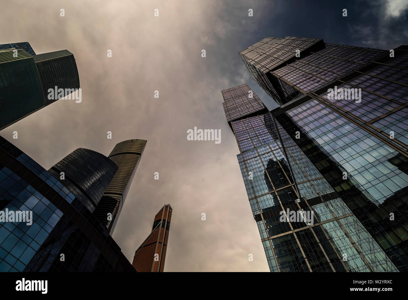 bottom-up view of rotating skyscrapers and flying clouds Stock Photo ...