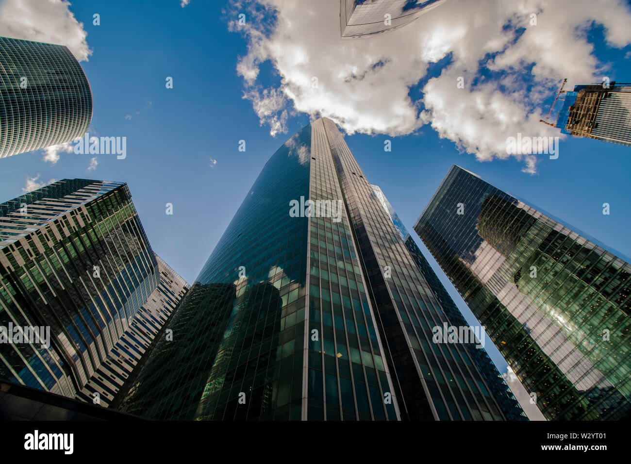 bottom-up view of rotating skyscrapers and flying clouds Stock Photo ...
