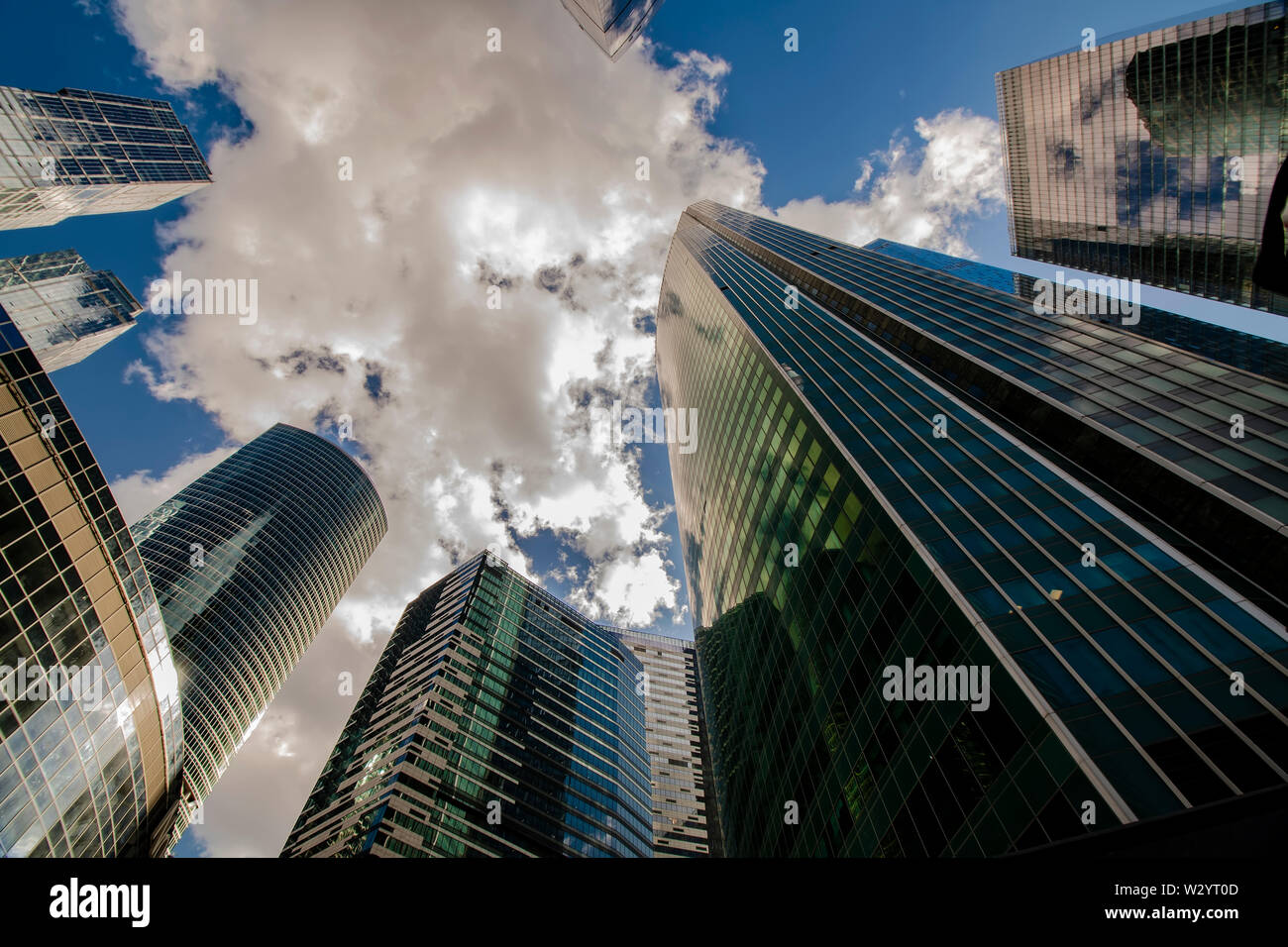 bottom-up view of rotating skyscrapers and flying clouds Stock Photo ...