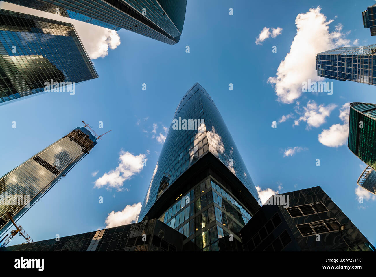 bottom-up view of rotating skyscrapers and flying clouds Stock Photo ...