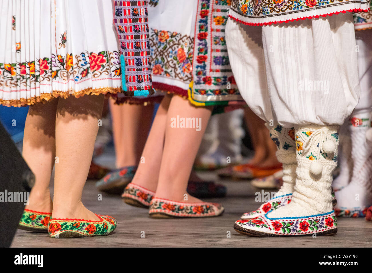 Close up of legs of young Romanian dancers perform a folk dance in ...